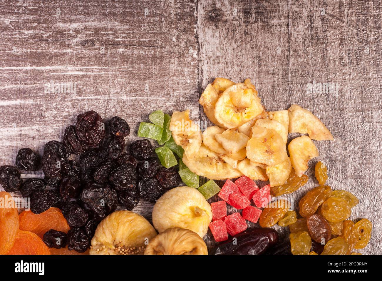 Different type of dried fruits on wooden background in studio photo ...