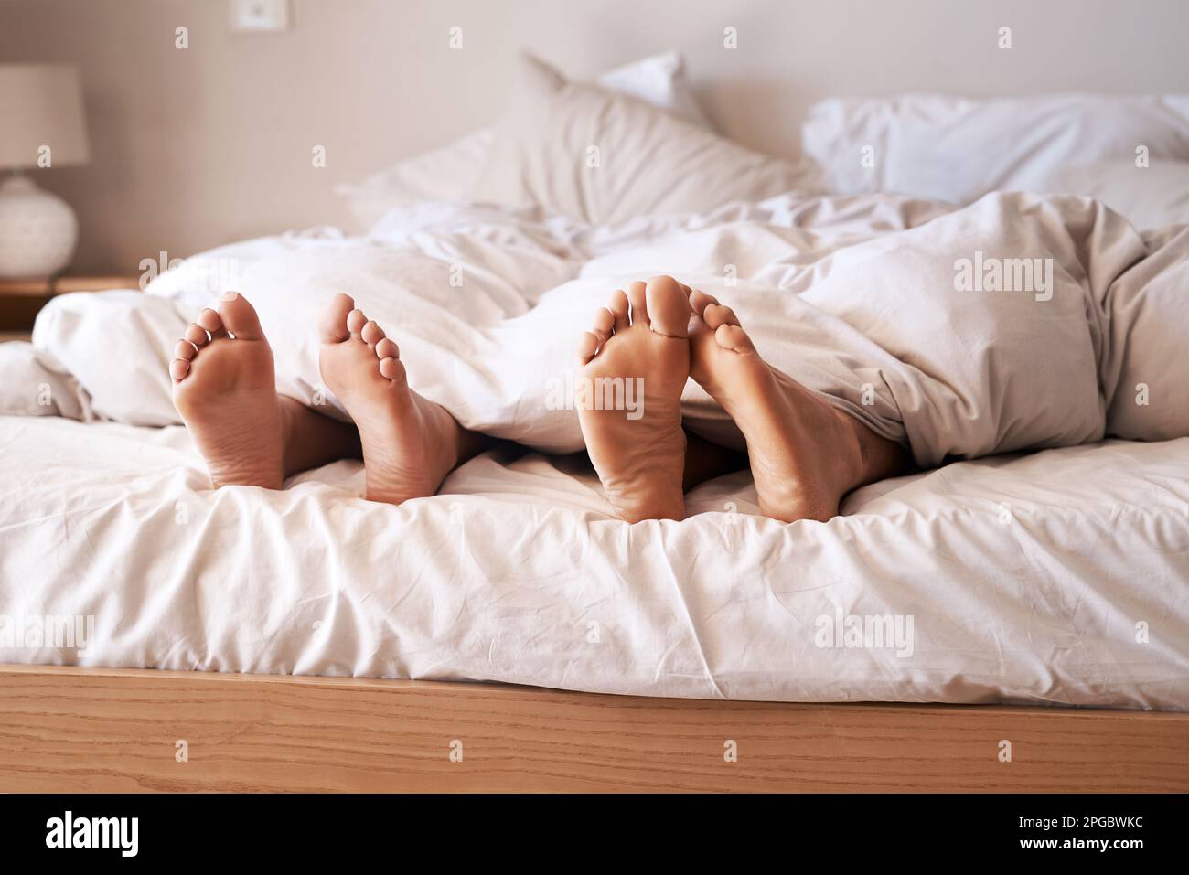 Stay In Bed All Day Challenge Accepted A Couples Feet Poking Out From Under The Bed Sheets