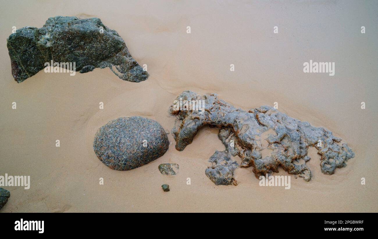 Top down view of large smooth volcanic stones washed by sea waves on a ...