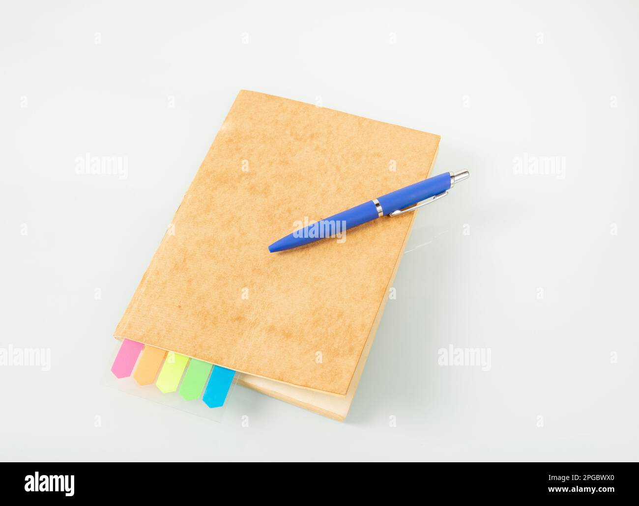 Office tools. Notebook with colored bookmarks and a blue fountain pen ...