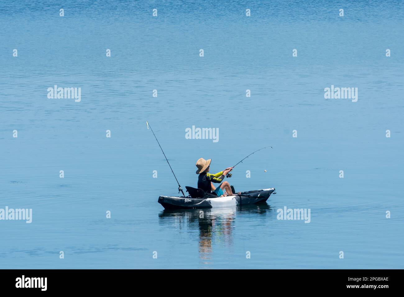 Fisherman fishing from a kayak on Lake Tinaroo, a popular scenic ...
