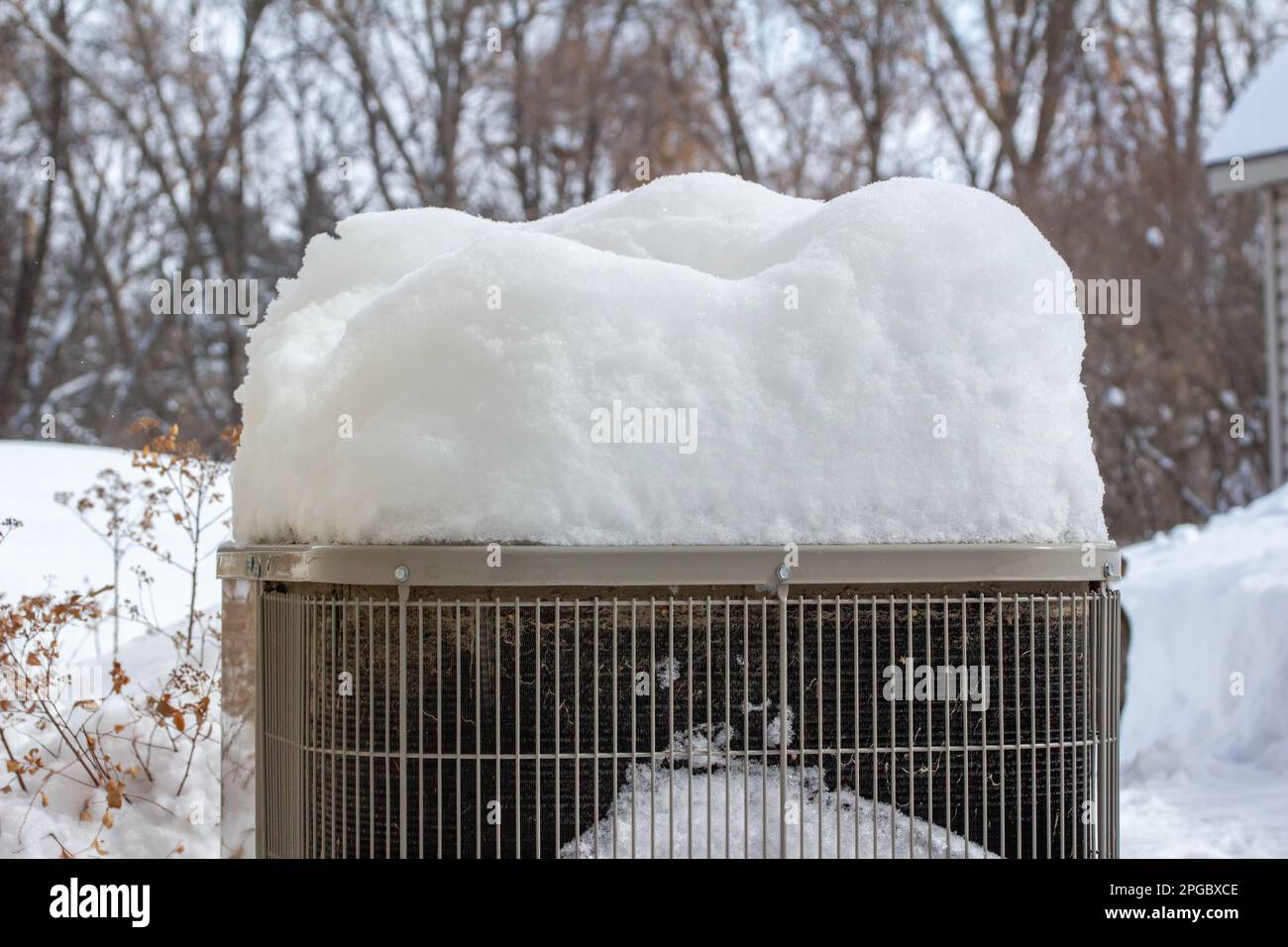 Close up view of an exterior home air conditioning unit, covered with ...