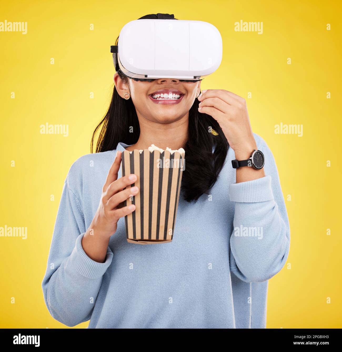 Woman is eating popcorn, happy and VR goggles with snack for watching ...