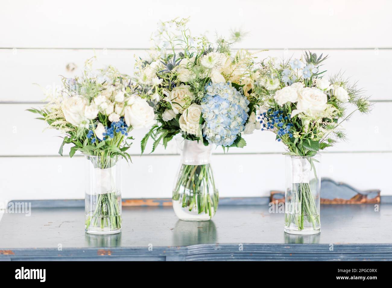 A trio of white floral arrangements in matching vases Stock Photo - Alamy