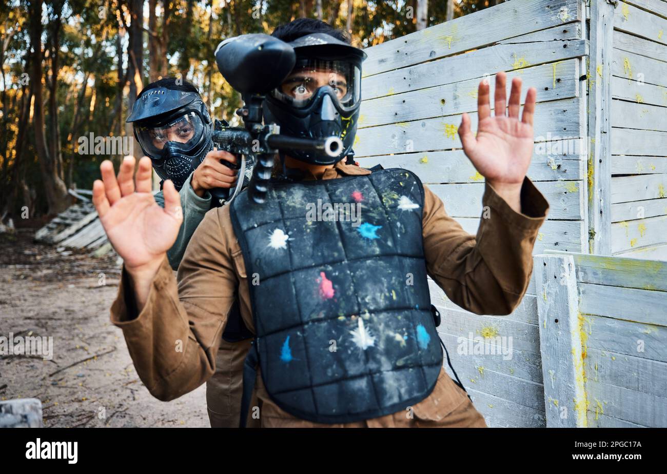 Man, paintball and hostage with gun in sports game, intense match or ...