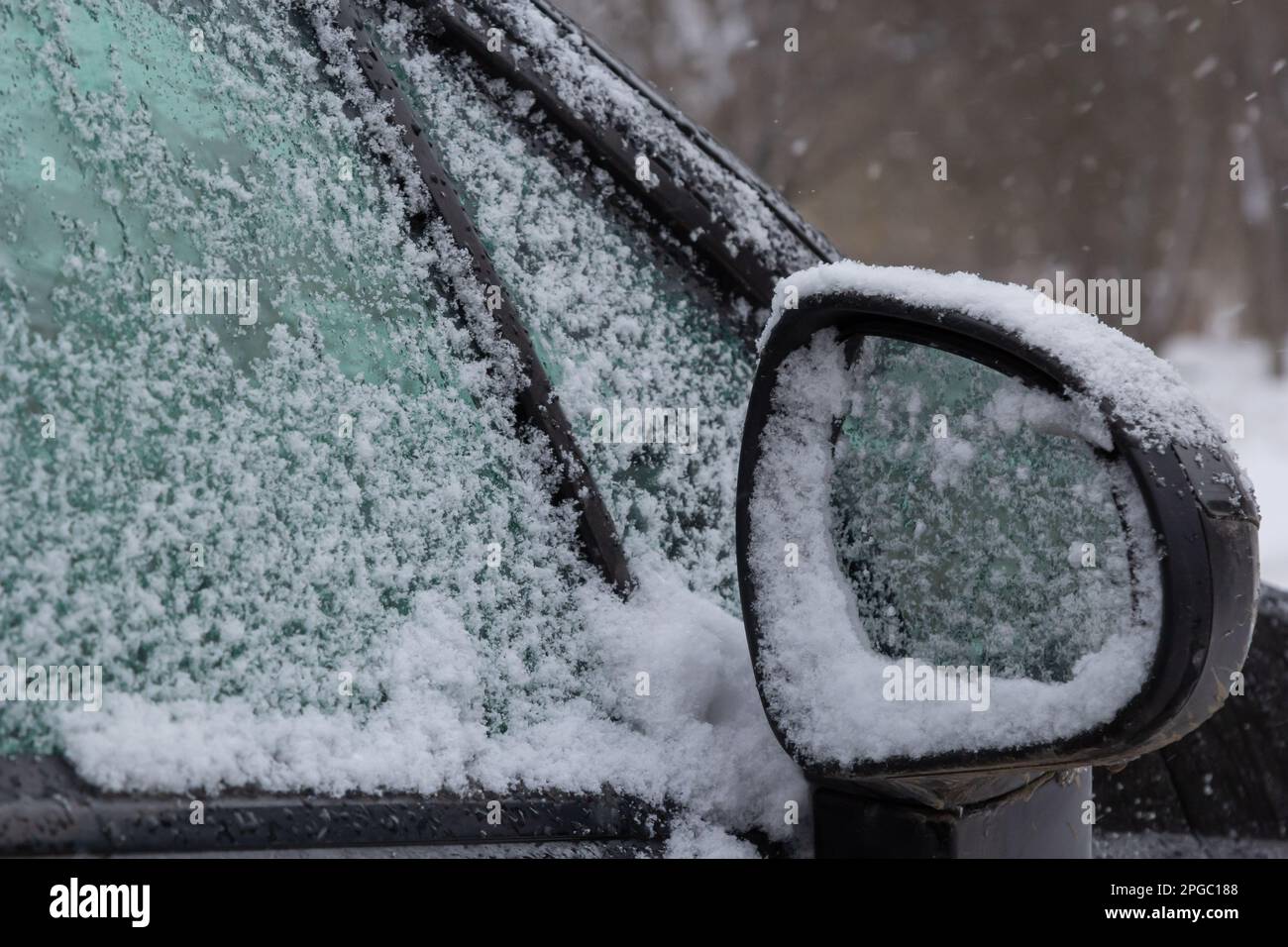 fresh snow covers the surroundings and the car mirror, snow texture on ...