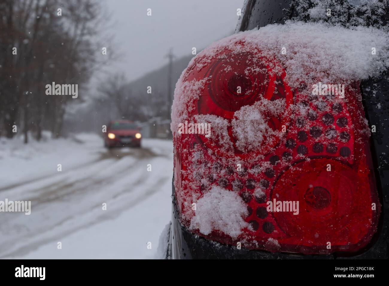 rear tail light of car covered in snow after blizzard on winter Stock ...