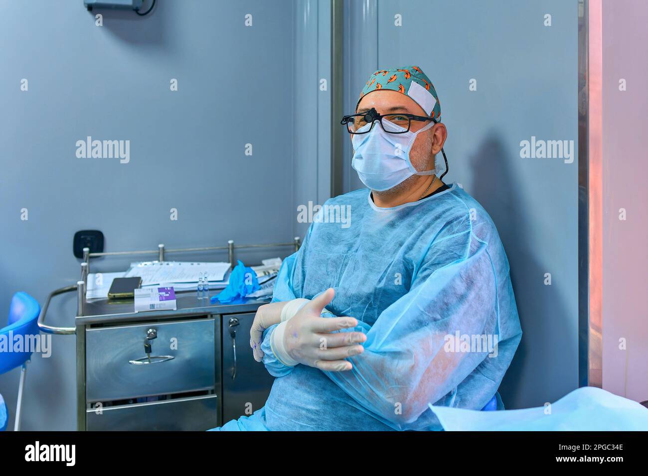 surgeon is sitting on a chair in the operating room Stock Photo - Alamy