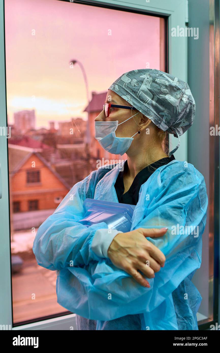 nurse looks out the window in the operating room Stock Photo - Alamy