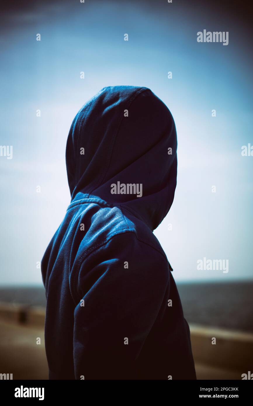 Rear view of hooded boy looking away Stock Photo - Alamy