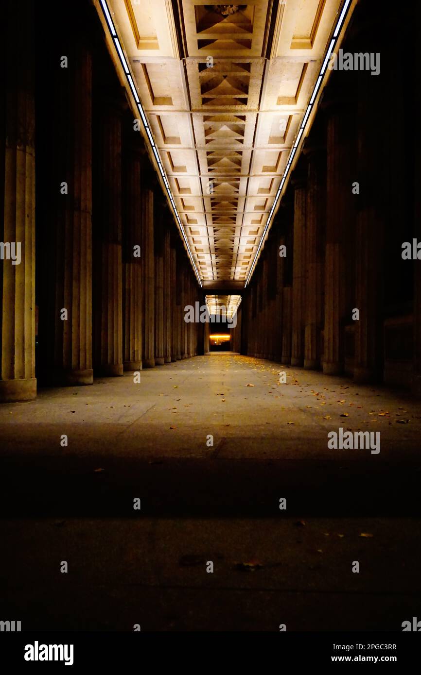 A dark underground walkway at night, with a view of the middle of the ...