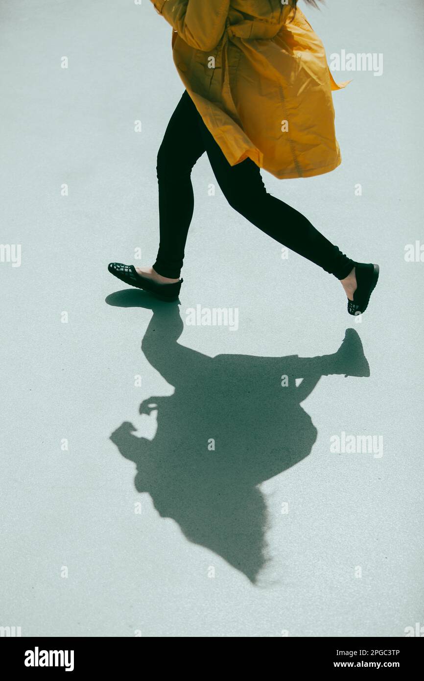 Woman in coat running side view hi-res stock photography and images - Alamy