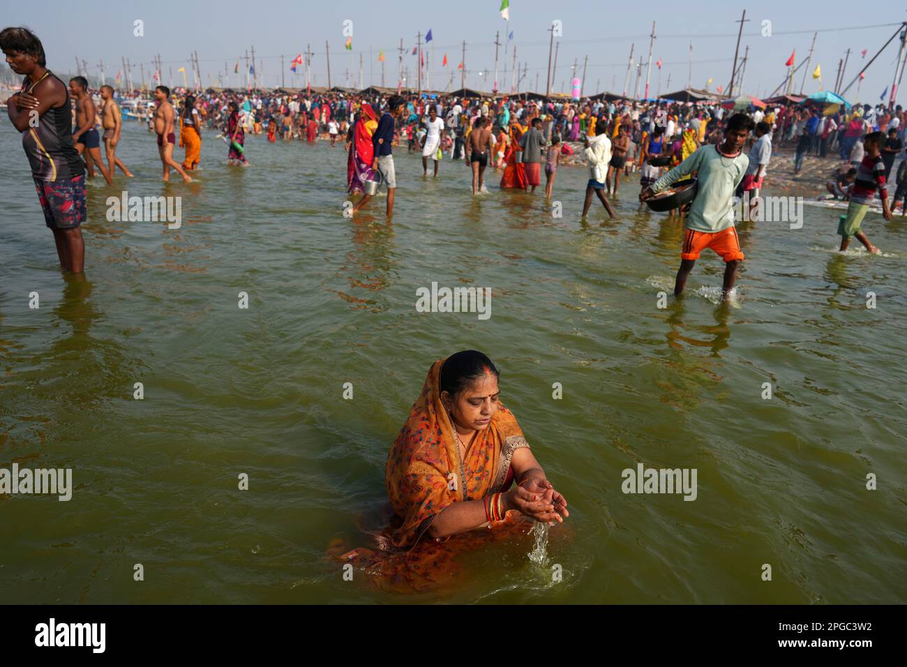 Hindu devotees perform morning rituals at Sangam, the confluence of the ...