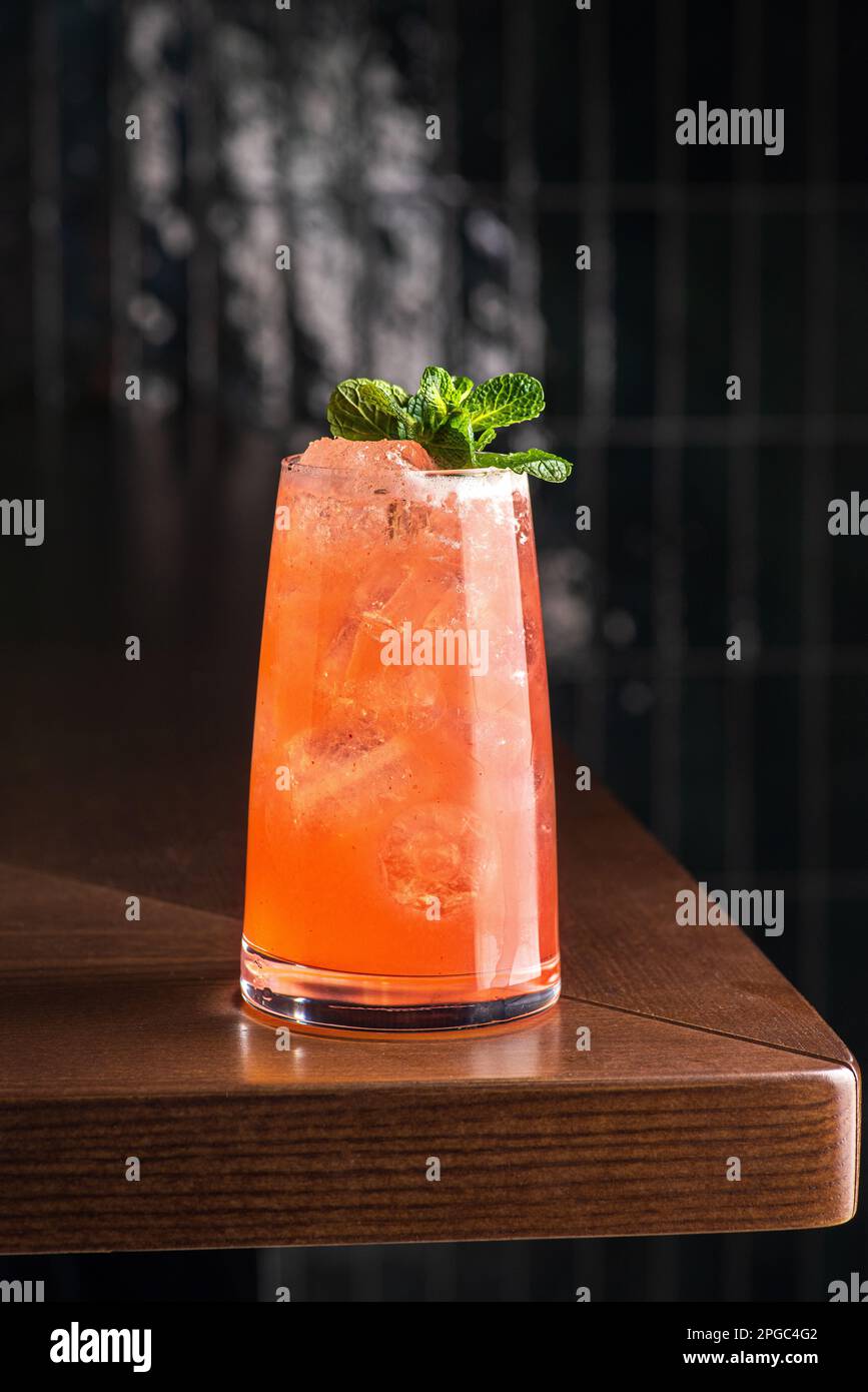 Highball glass of cocktail with red grapefruit and gin with vodka with ...