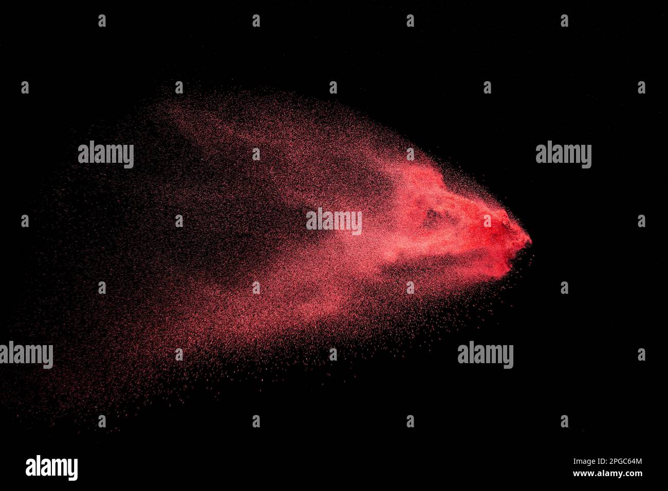 Red dust particles explosioon on black background.Red powder splash ...