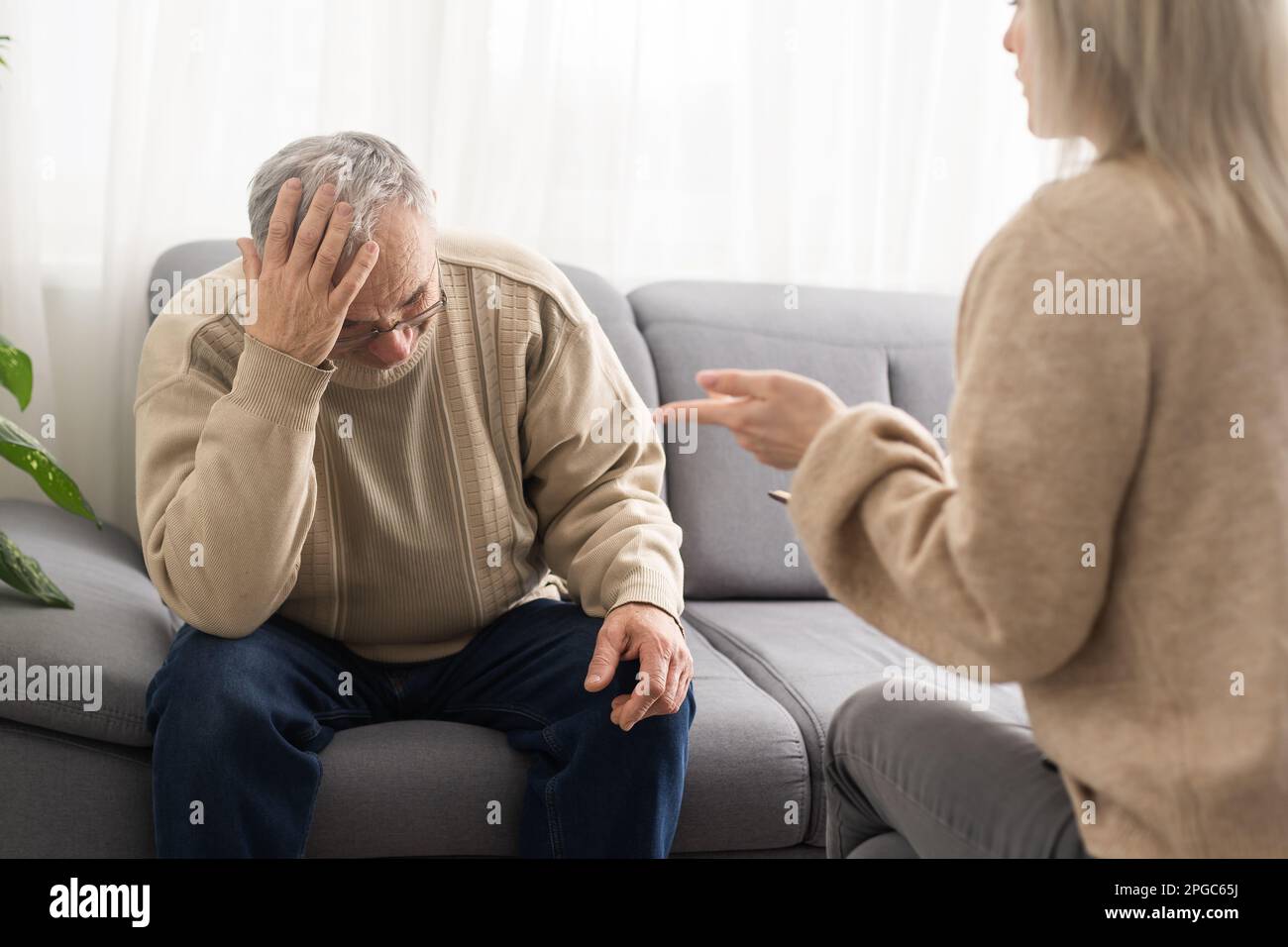 Senior man patient and young woman caregiver medical worker in uniform ...