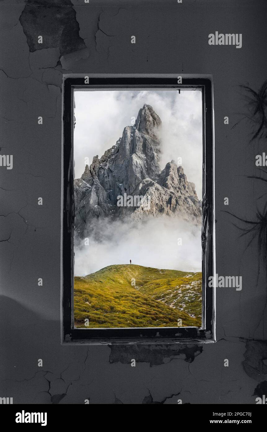 A window opens to a scenic view of a majestic mountain range outside ...