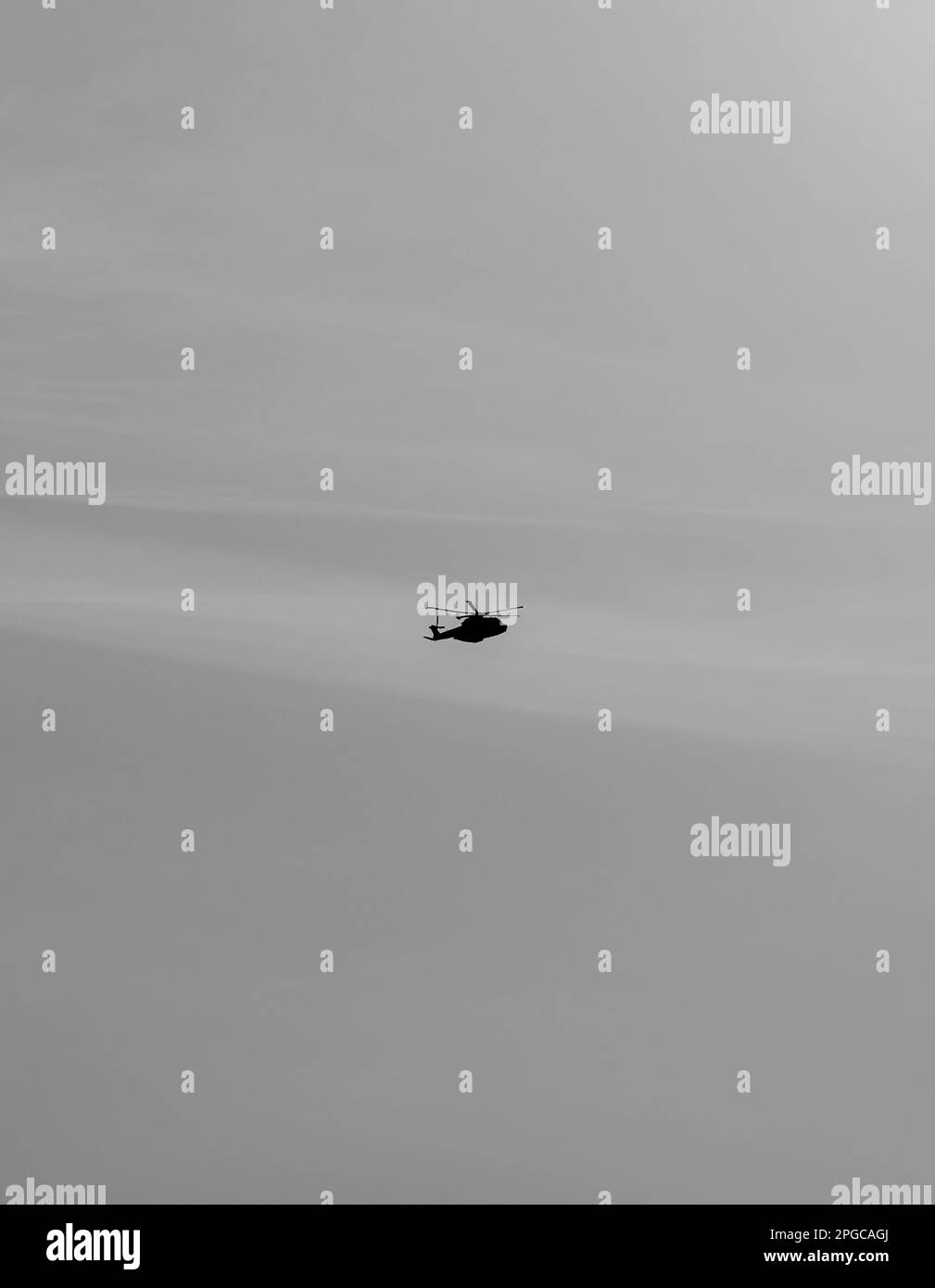 A helicopter flying high in the sky Stock Photo - Alamy