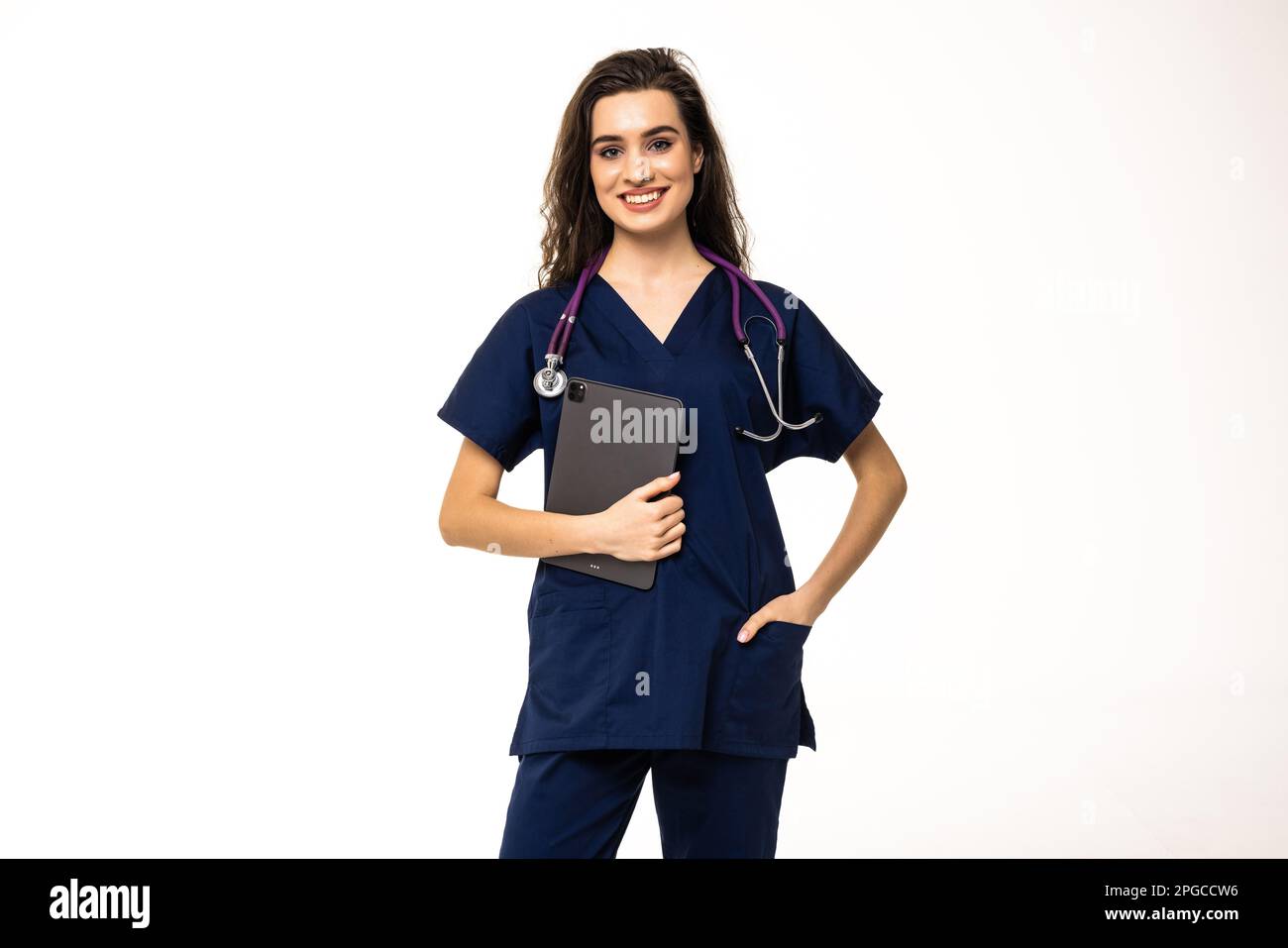 Portrait of attractive skilled nurse doctor using tablet reading ...