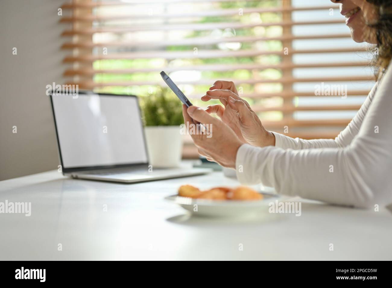 Cropped image of an Asian-aged woman using her smartphone, chatting ...