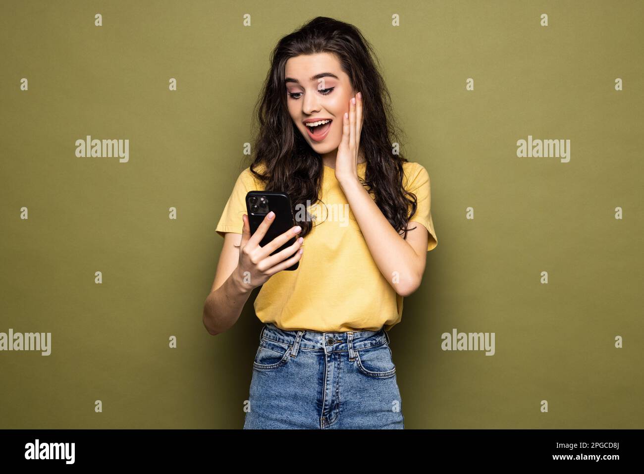 Full body young y woman sit use mobile cell phone isolated on khaki ...