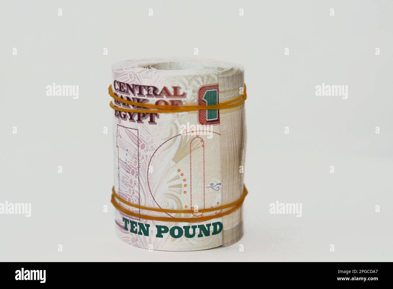 10 EGP LE ten Egyptian pounds cash money bills rolled up with rubber ...