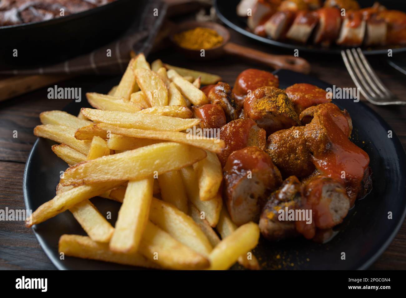 Homemade french fries with german curry sausage on rustic table Stock ...