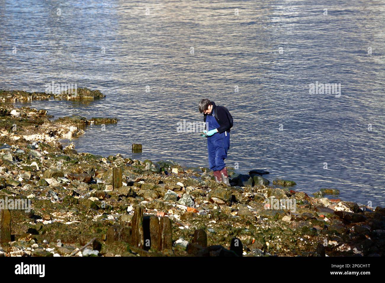 Female mudlark looking for artefacts and things of interest on ...