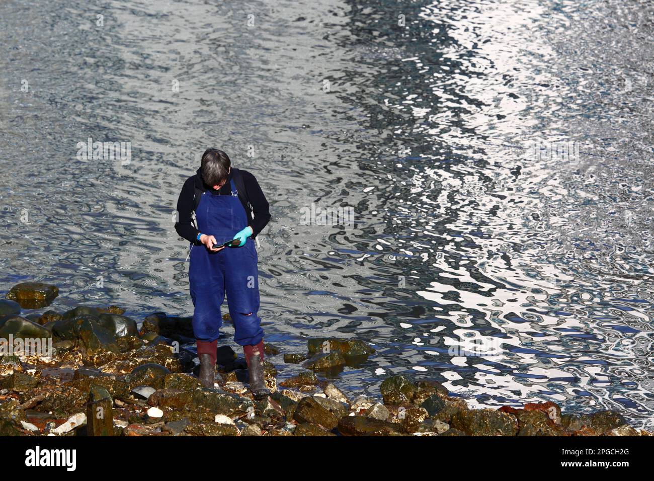 Female mudlark looking for artefacts and things of interest on ...