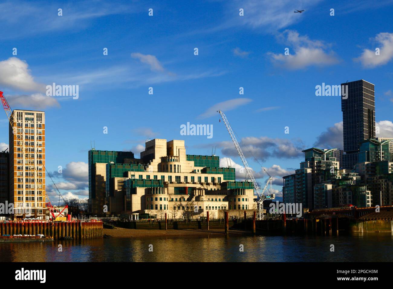 View across River Thames from Millbank to MI6 building and cranes on ...