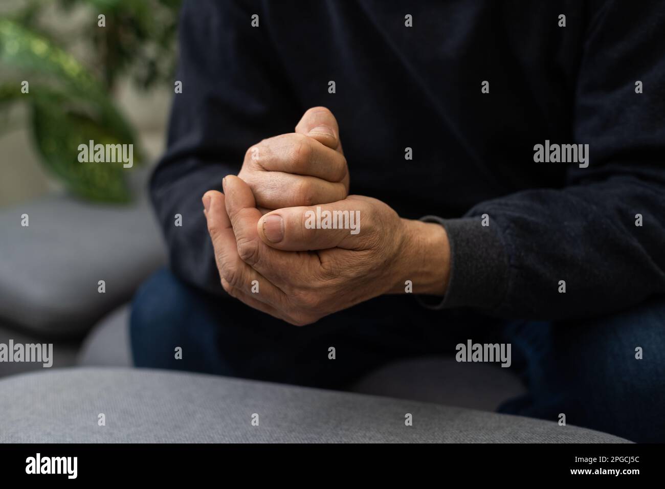 Seated senior man folded hi-res stock photography and images - Alamy