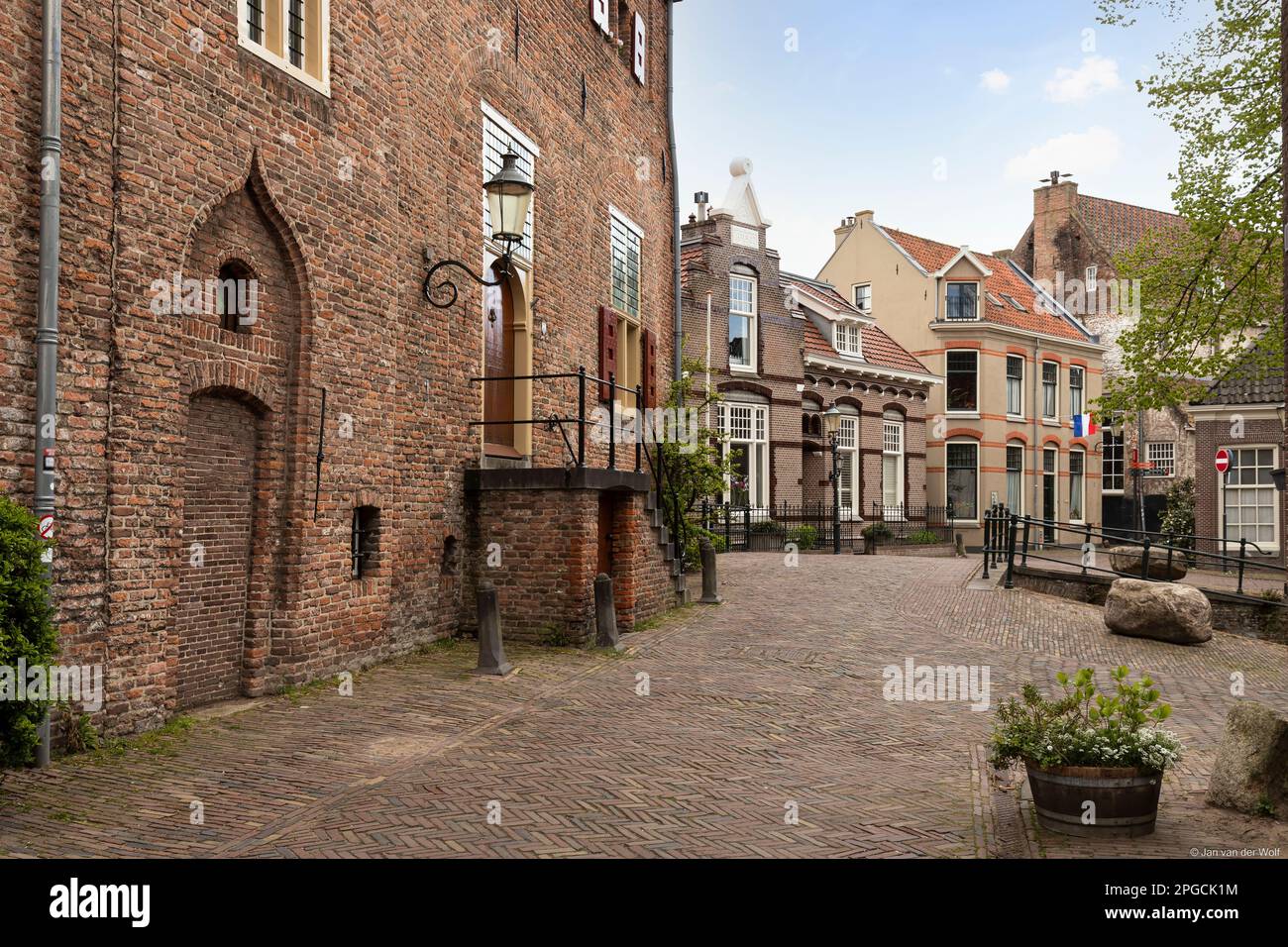 Narrow street with Dutch flags in the old medieval center of the Dutch ...