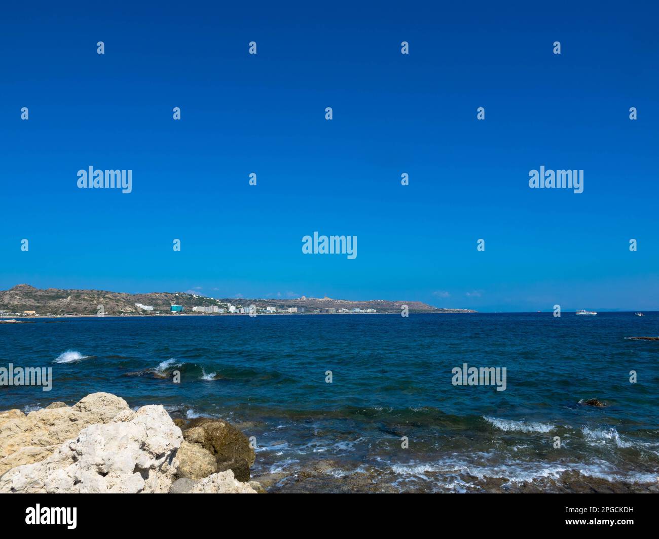 Panoramic view of the turquoise Aegean Sea with plants and hills. In ...