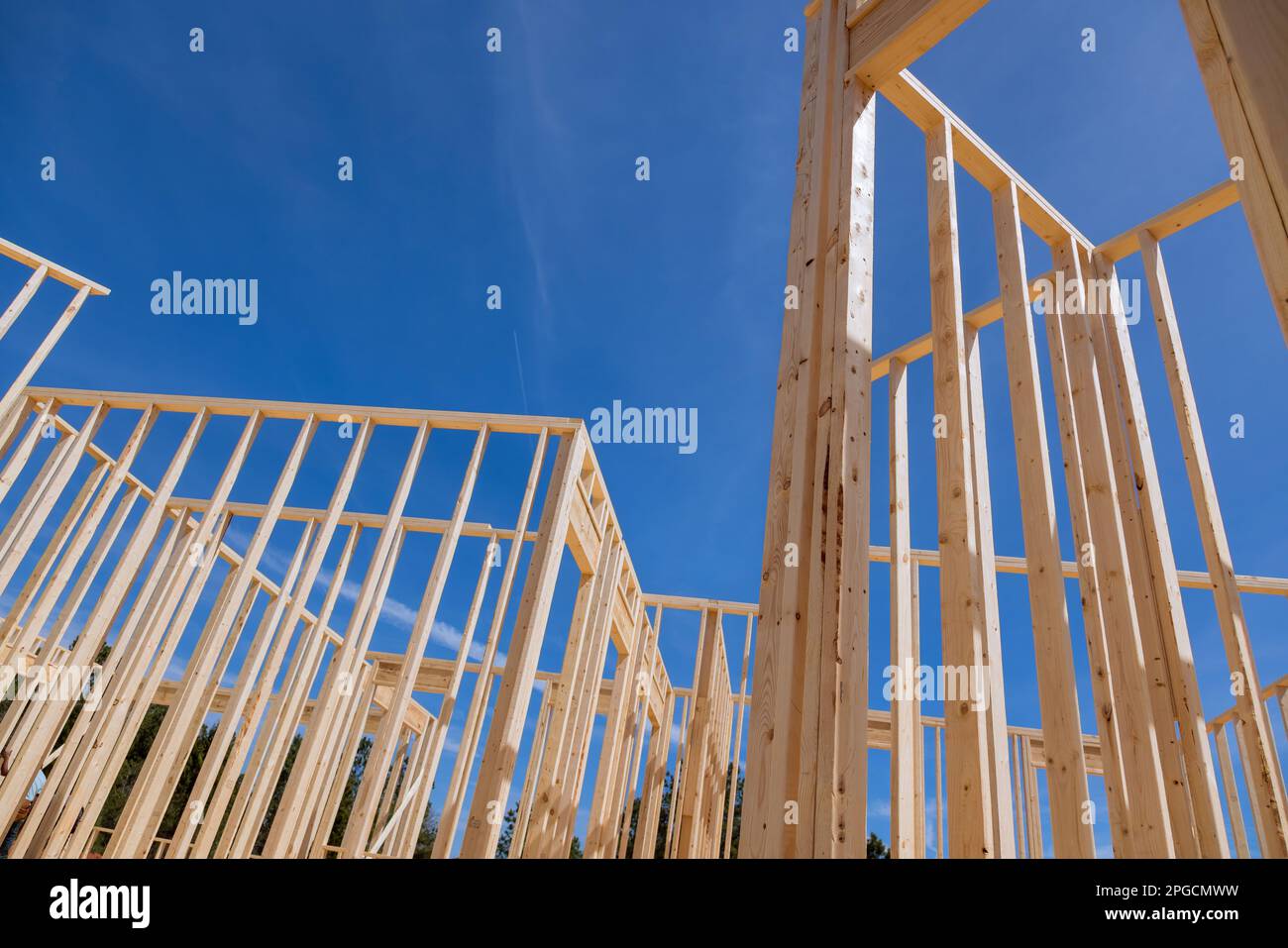 Construction crew carefully positioned framing beam in place before ...
