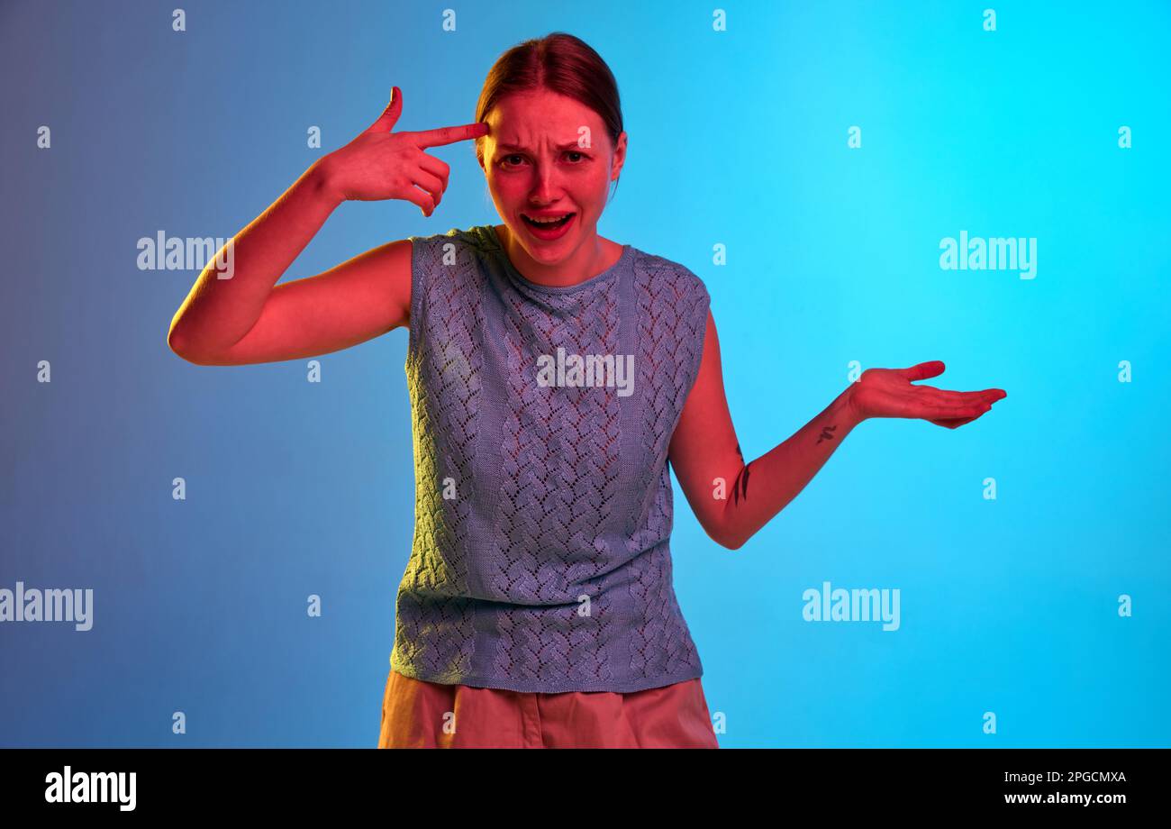 Surprised girl standing and looking with questioning facial expression ...