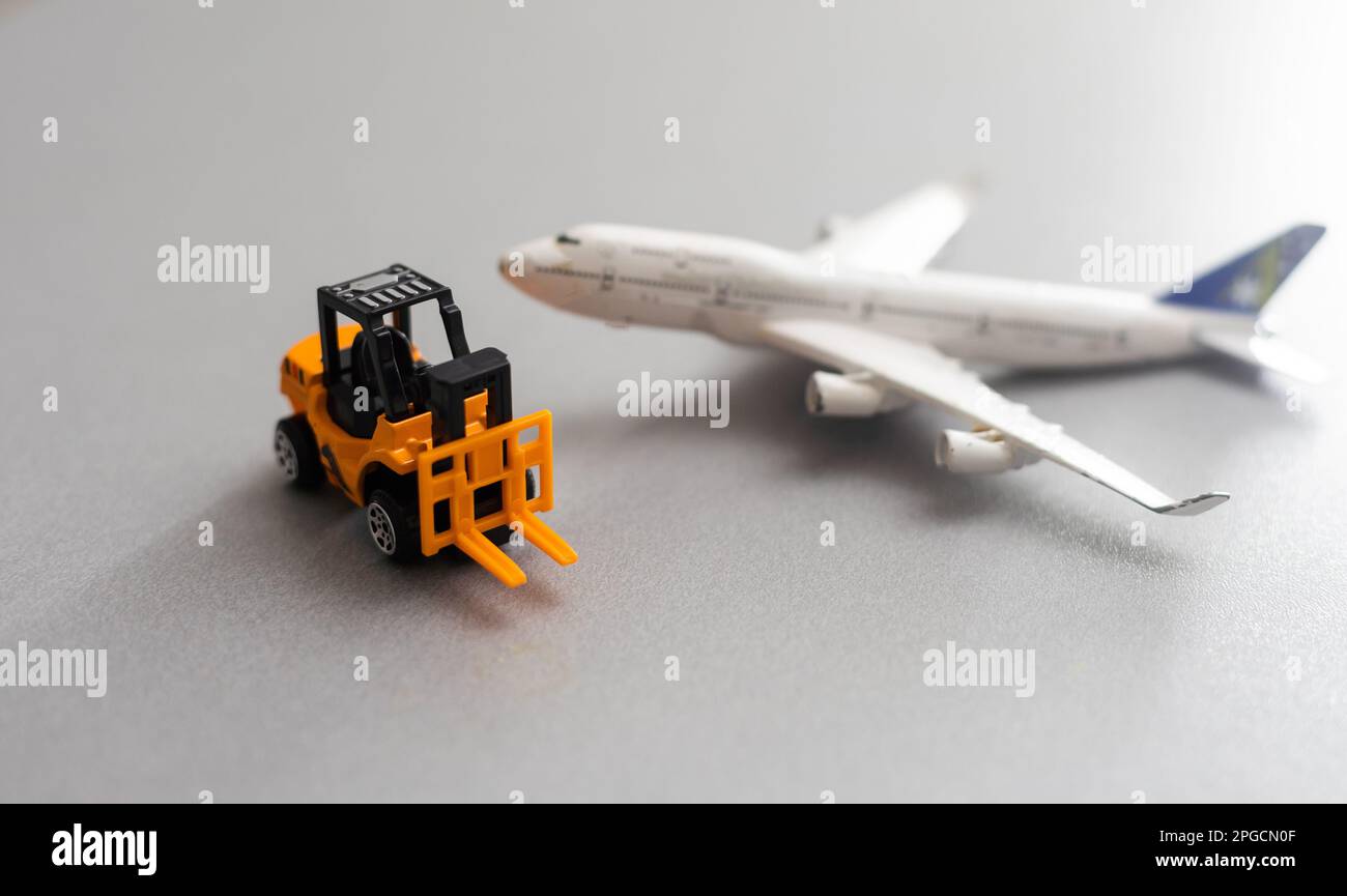 toy excavator and plane. Industry concept Stock Photo - Alamy