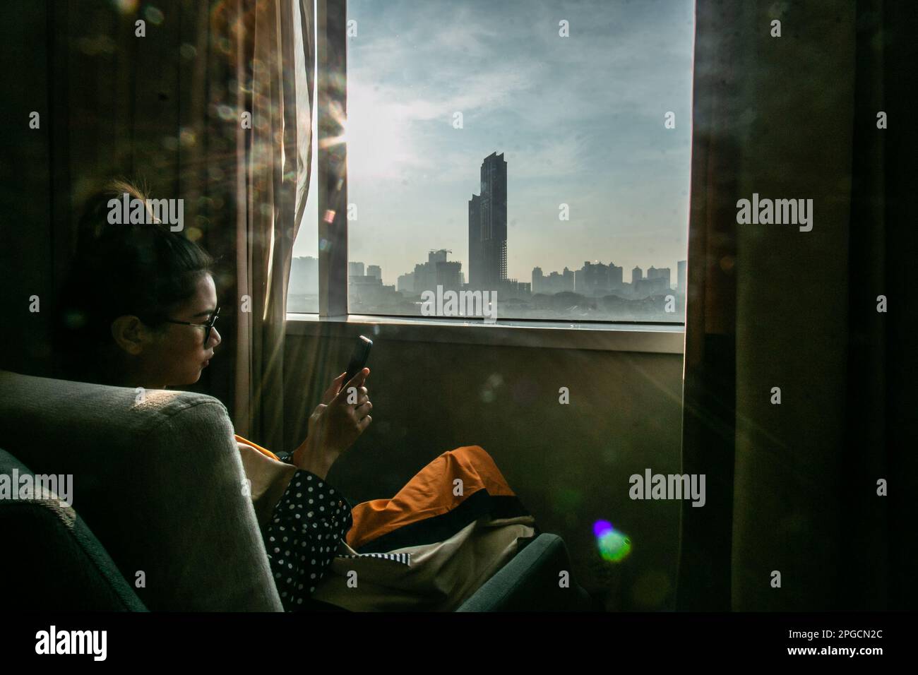 JAKARTA, INDONESIA - March 21, 2023: A woman with her cell phone inside ...