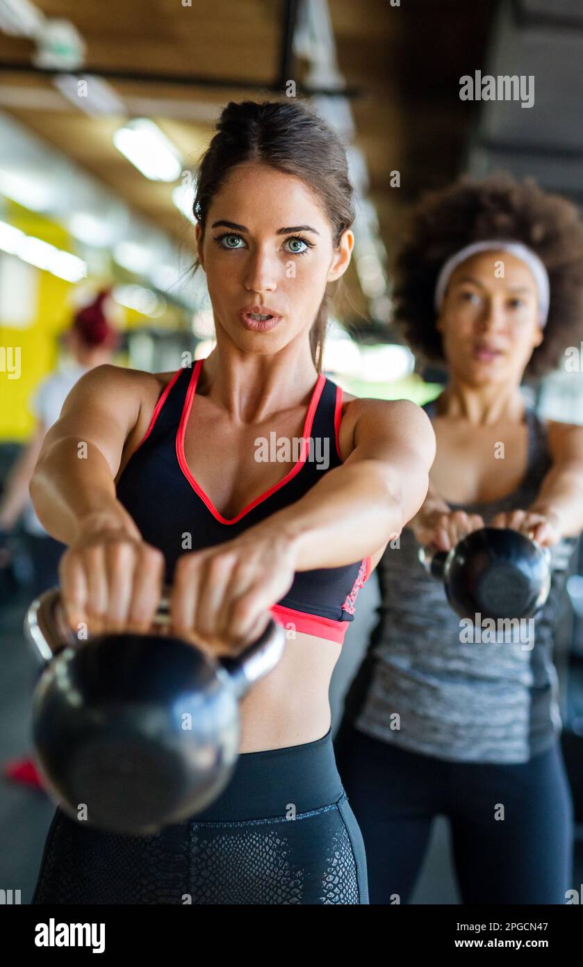 Group of fit people lifting dumbbells during an exercise class at the ...
