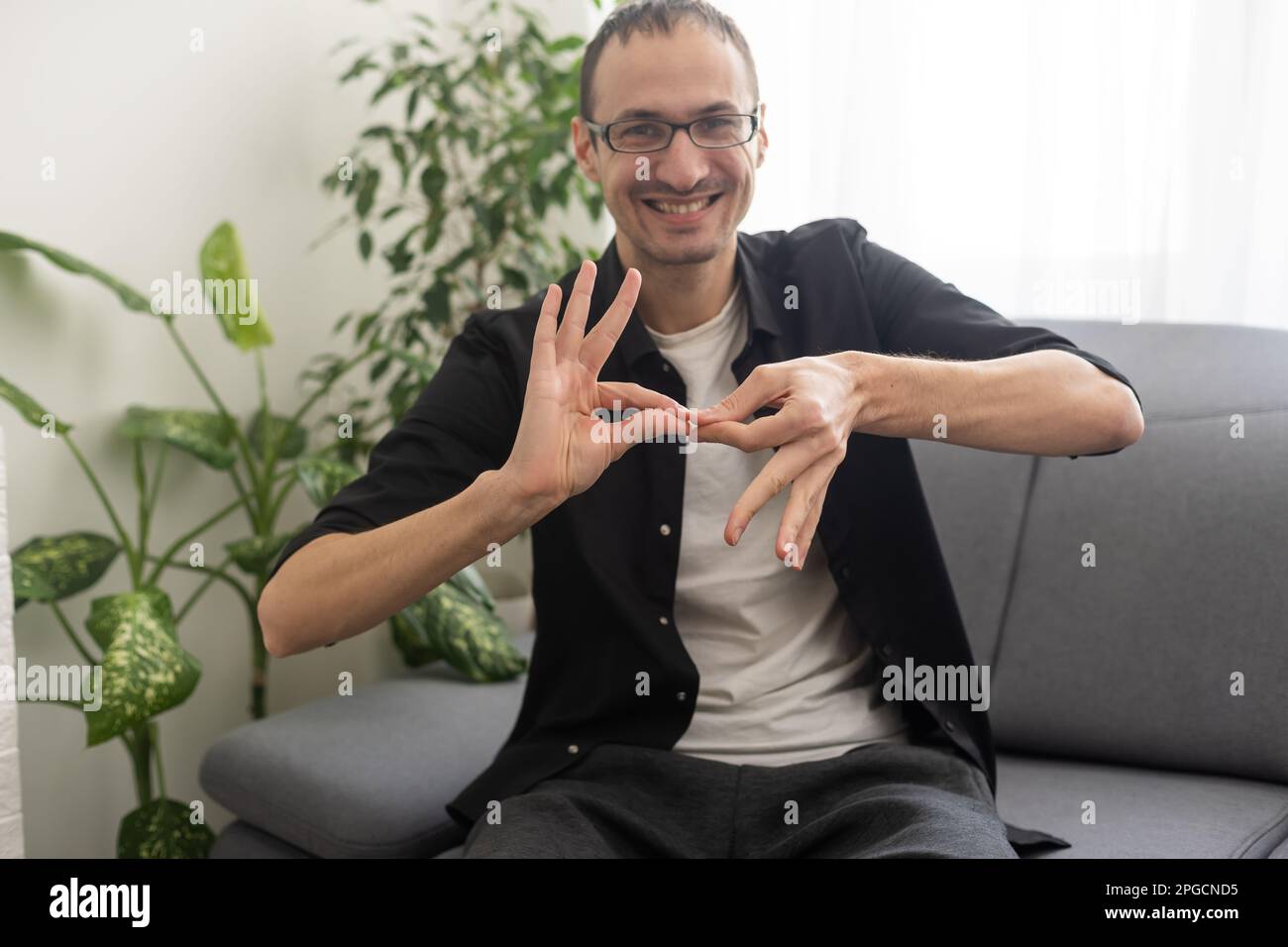 Adult Learning Sign Language For Deaf Disabled Stock Photo - Alamy