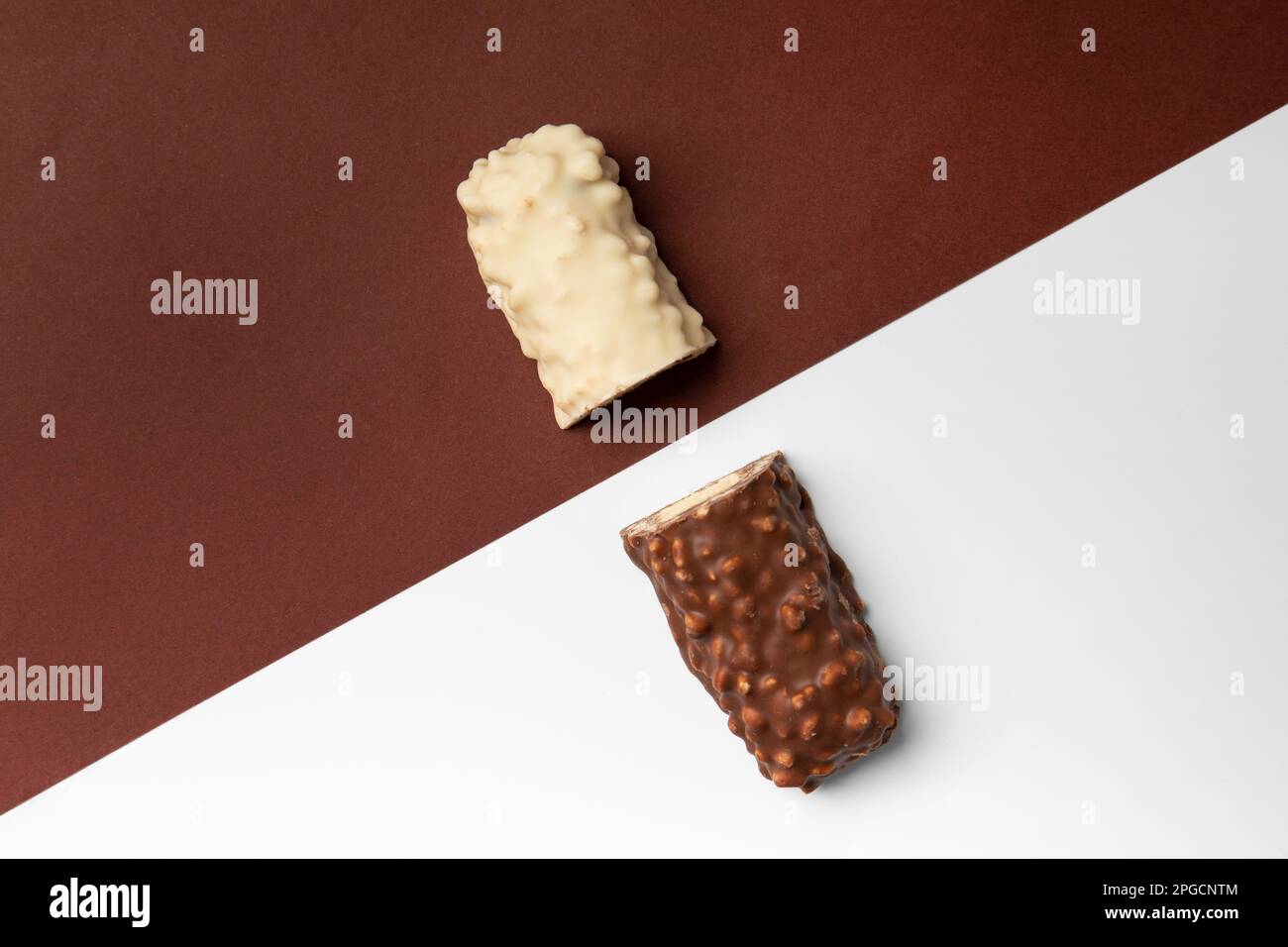 White and milk cut bar on a colored background top view. Conceptual ...