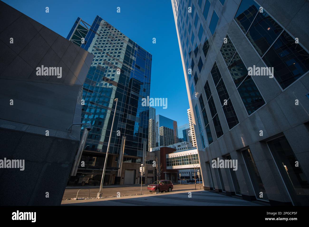 Red colored car driving on traffic free asphalt road with contemporary ...