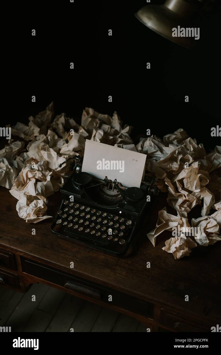 From above retro home office with wooden table and vintage typewriter ...