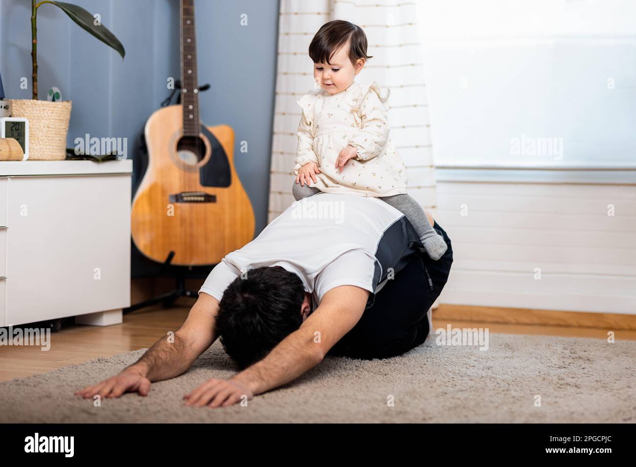 Full body of faceless father in casual clothes stretching body with ...