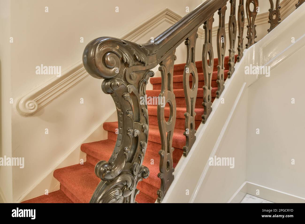 Interior of hall with red carpet stairway with antique bronze metal ...