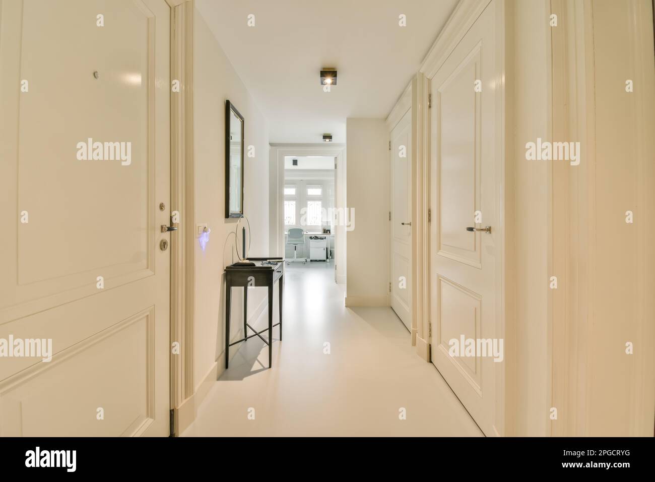 Interior design of long corridor with white doors and dressing table ...