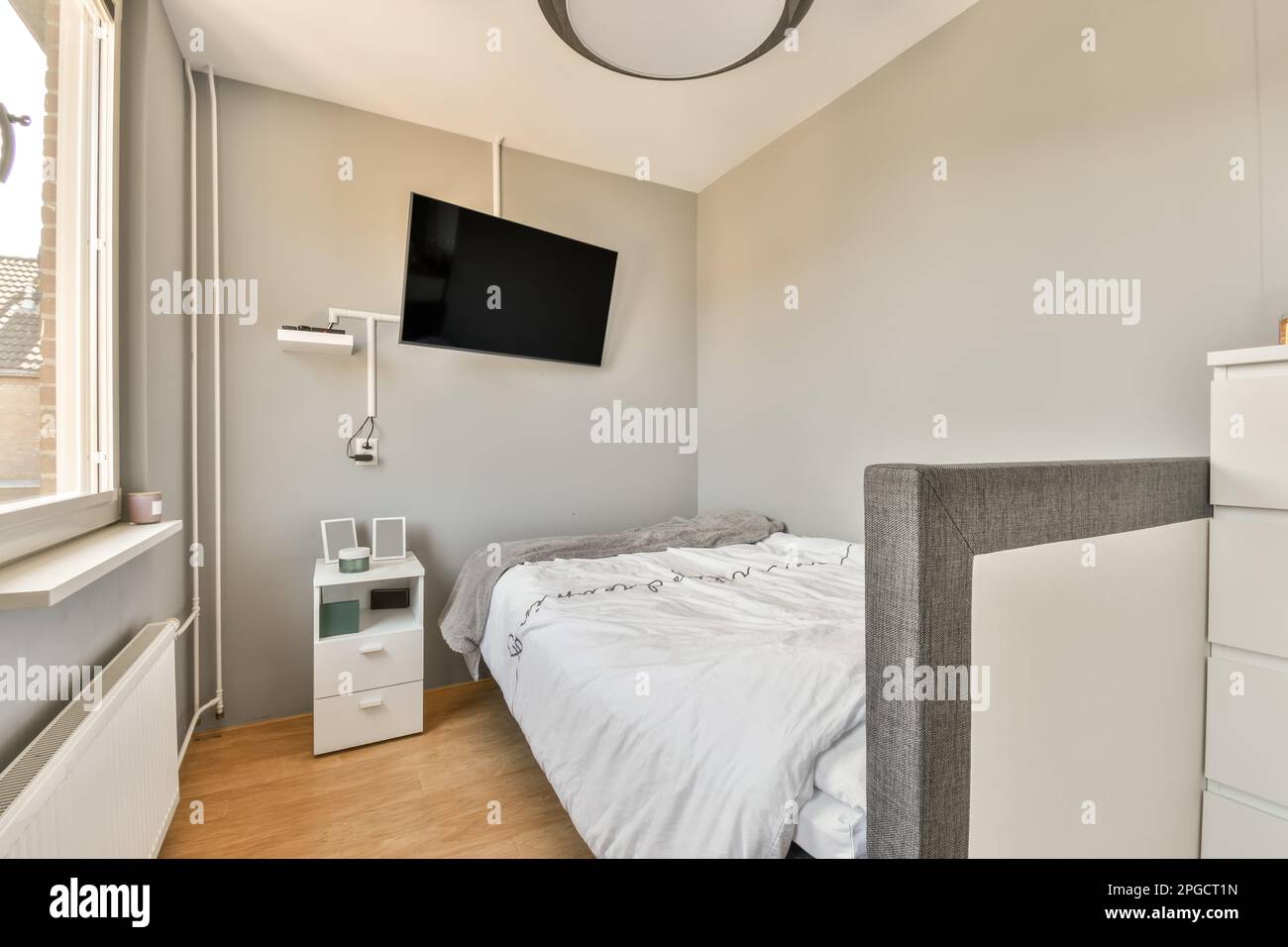 Side view of interior design of compact bedroom in window daylight with ...