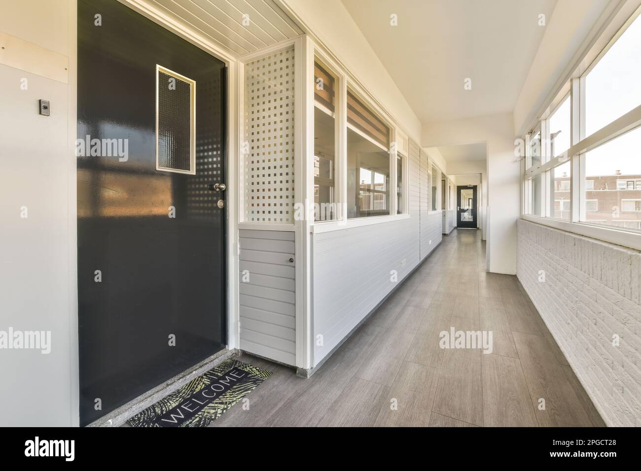 Interior design of spacious long empty hallway with wooden floor and ...