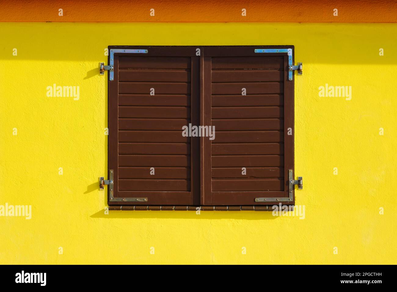 Colorful facade with closed window Stock Photo - Alamy