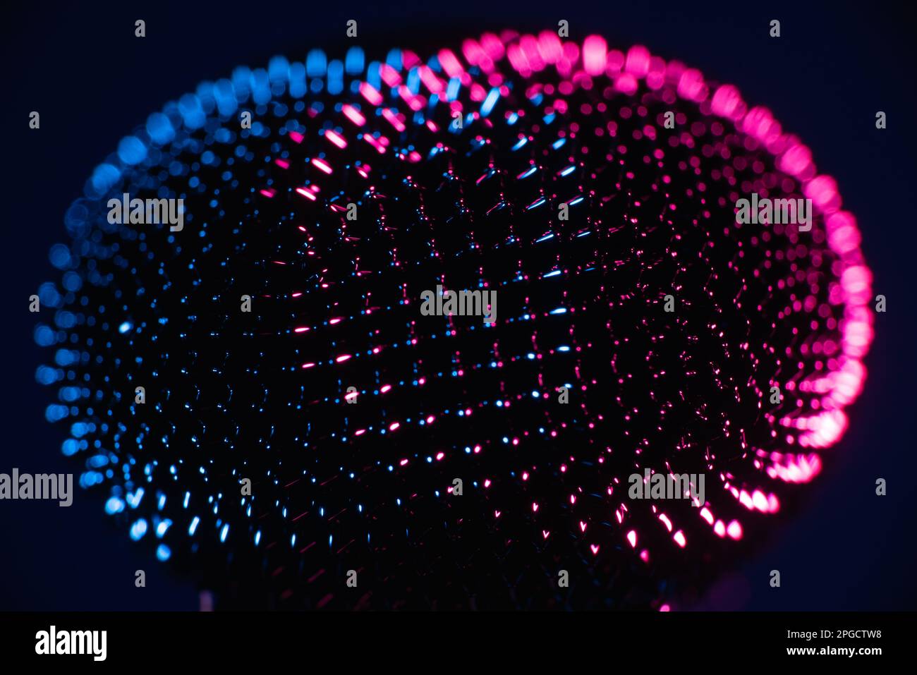 Closeup wonderful ferrofluid spikes shining under bright neon light ...