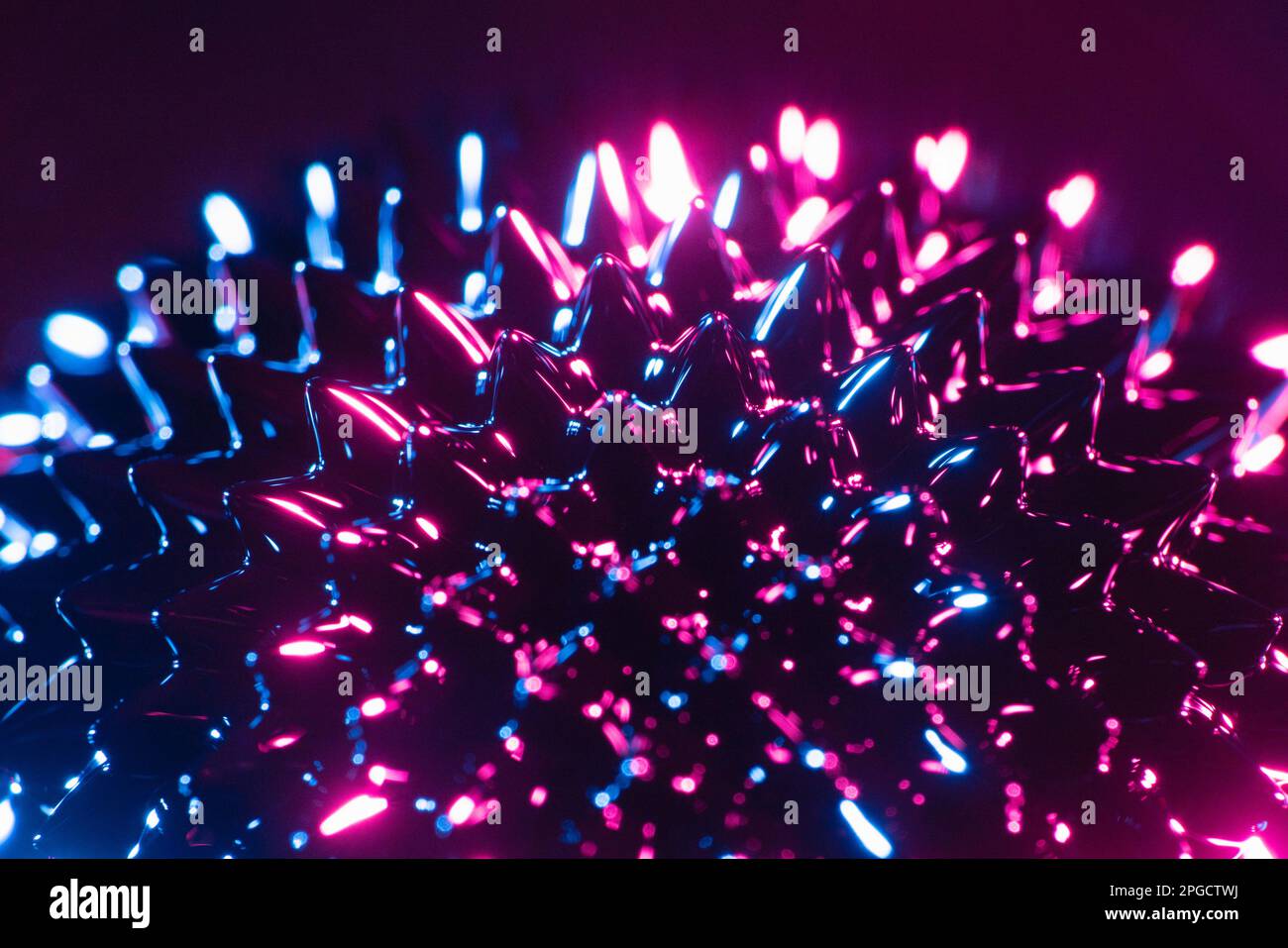 Closeup wonderful ferrofluid spikes shining under bright neon light ...